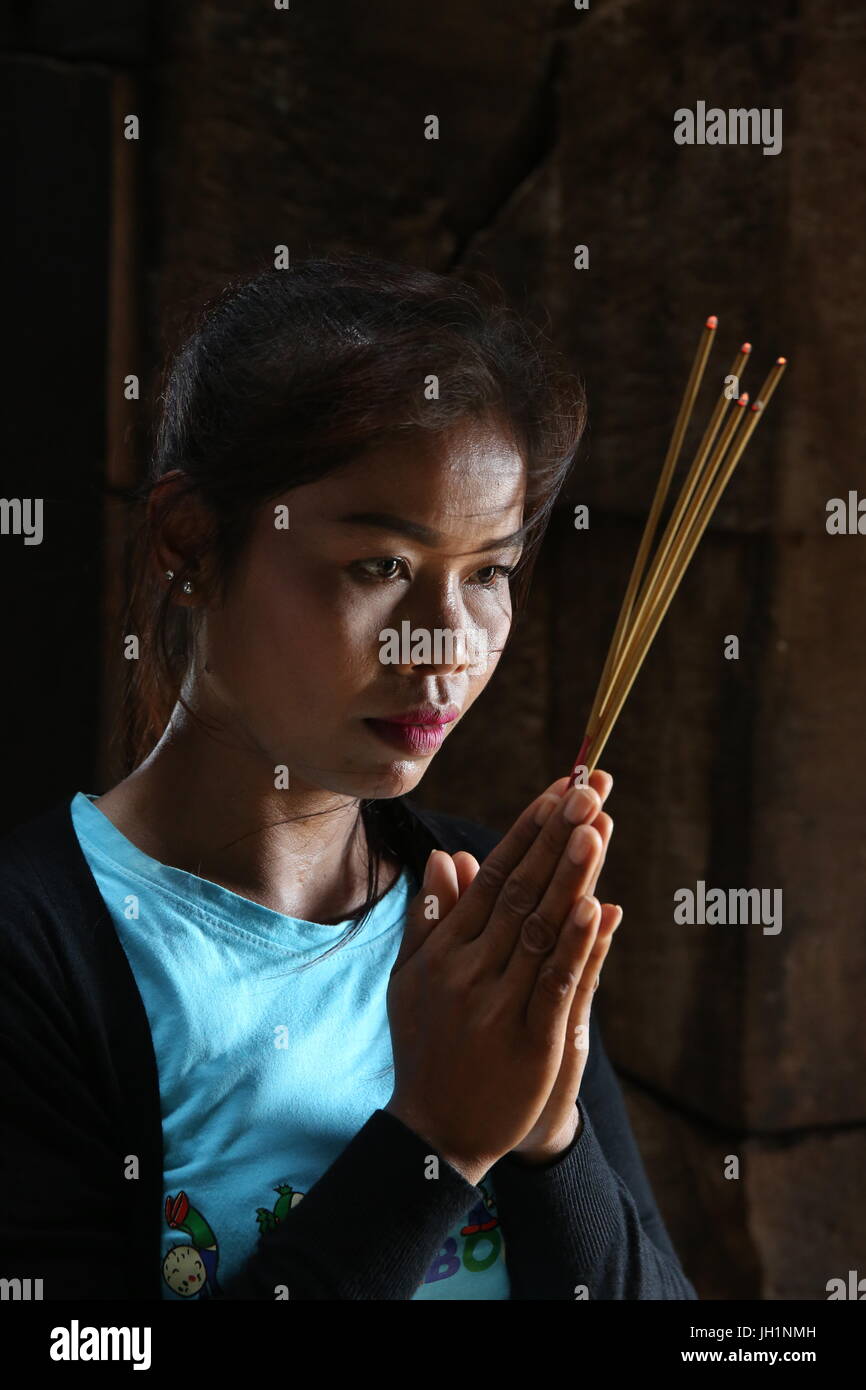 Woman praying at temple hi-res stock photography and images - Alamy