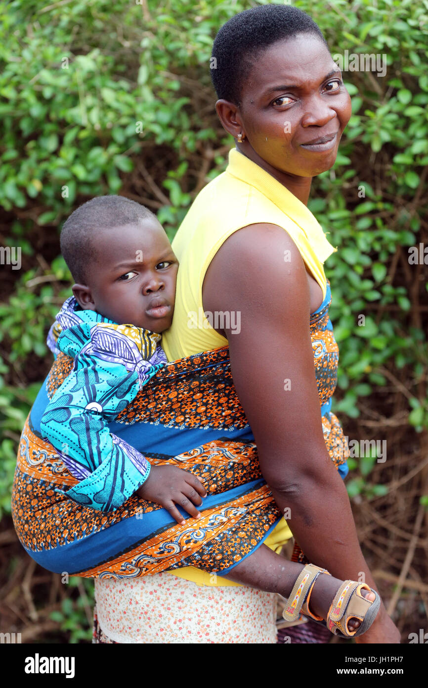 African baby carried on the back of his mother. Togo Stock Photo - Alamy