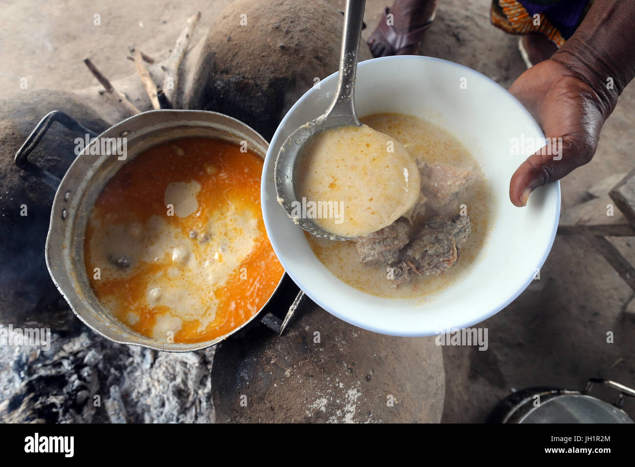 African meal cooking over a fire. Togo Stock Photo - Alamy