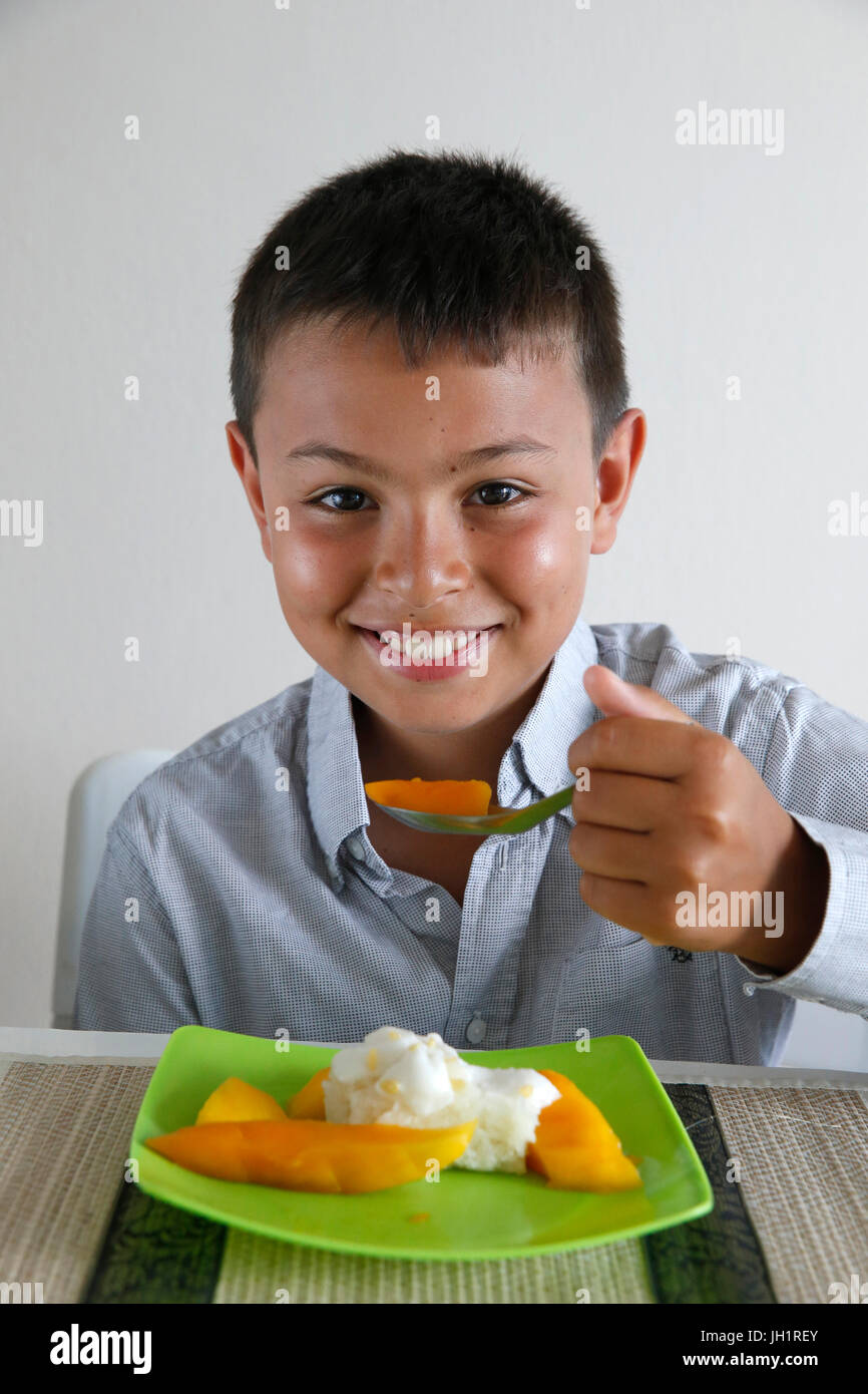 Child eating rice hi-res stock photography and images - Alamy