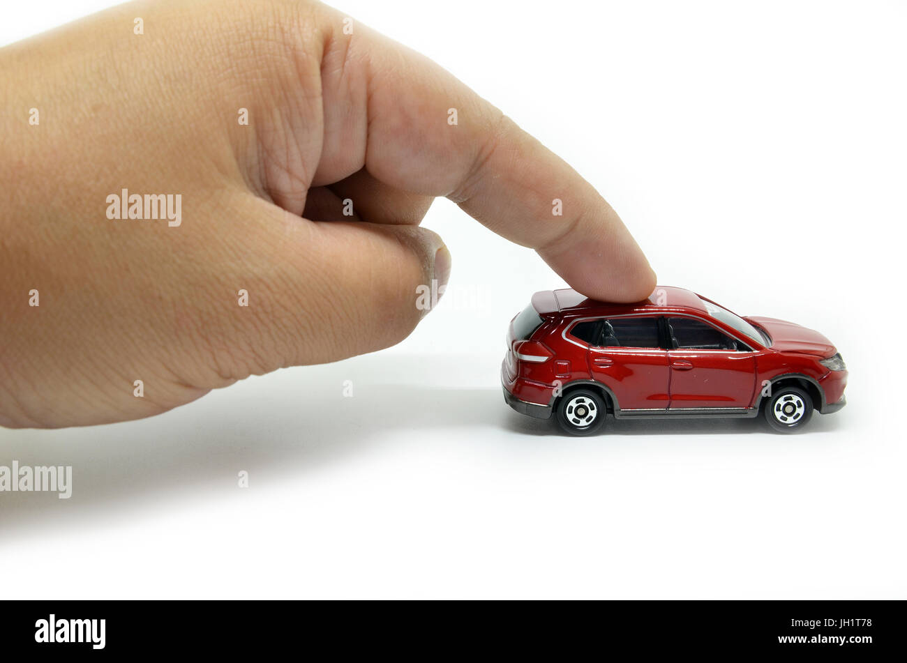 The finger of the businessman moves the toy car Stock Photo - Alamy