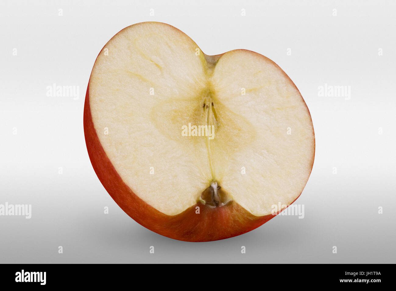 Half of a red apple on white background in a front view with clipping ...