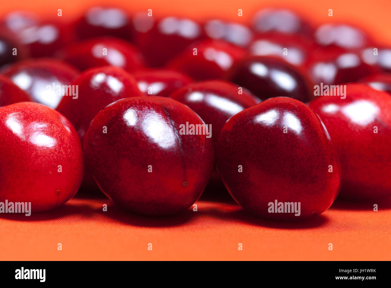 Sweet red cherries fruit background. Studio shoot Stock Photo - Alamy