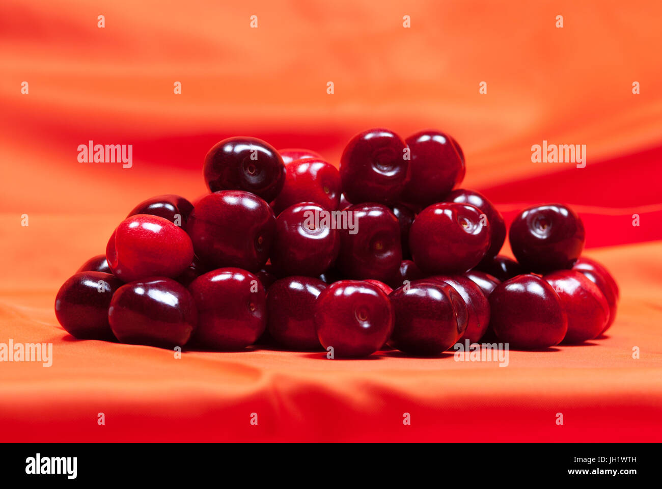 Sweet red cherries fruit background. Studio shoot Stock Photo - Alamy
