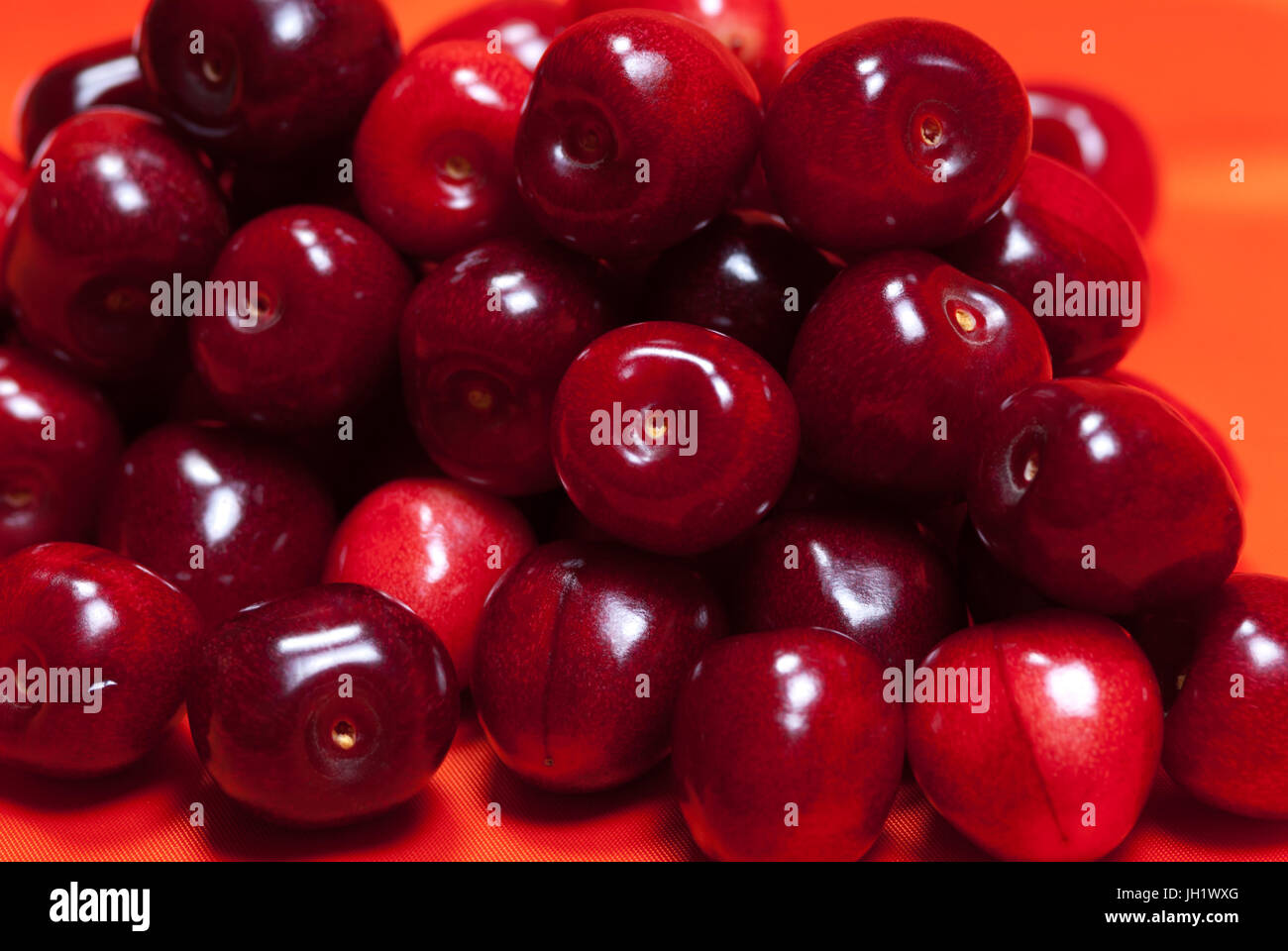 Sweet red cherries fruit background. Studio shoot Stock Photo - Alamy