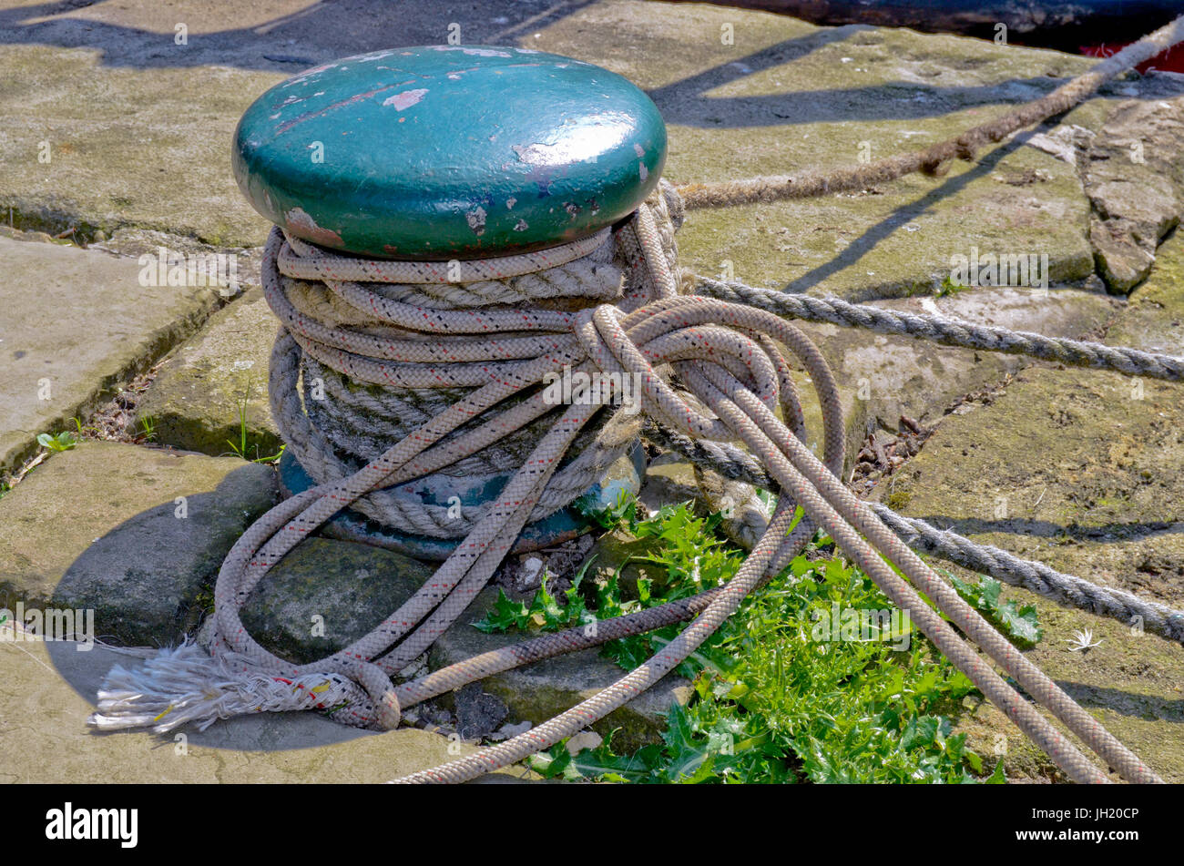 Mooring post with ropes on canal banking at hebden bridge, yorkshire ...