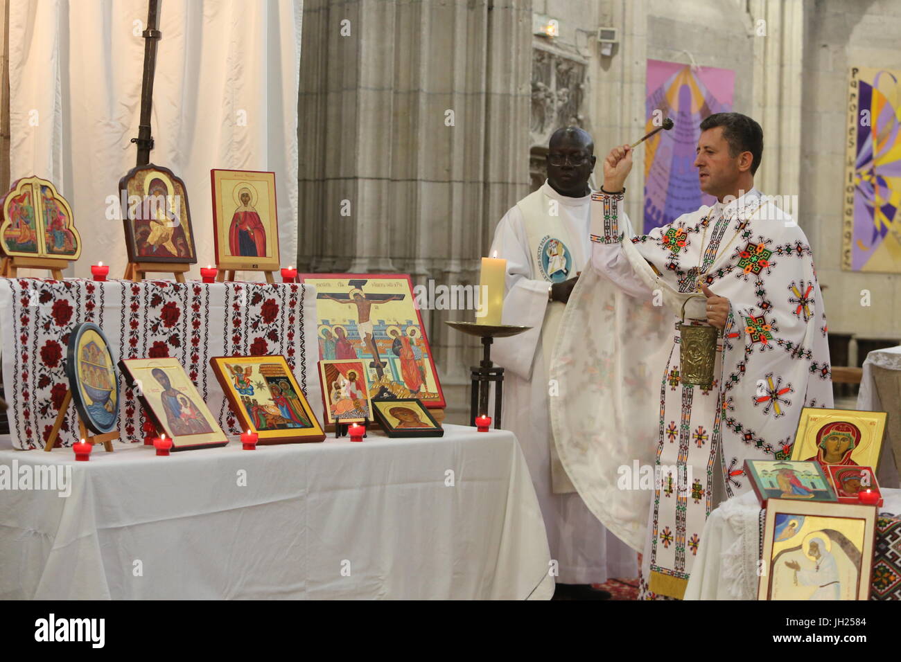 Melkite (Greek-catholic) priest blessing icons in Sainte Foy church ...