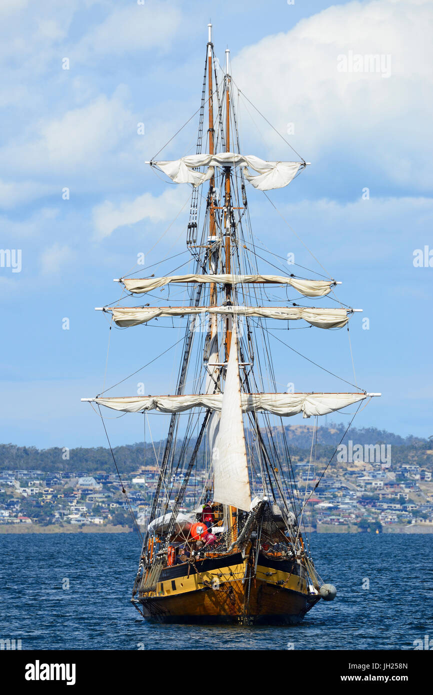 Two-masted square rigged tall ship "Windeward Bound" furls sails as it ...