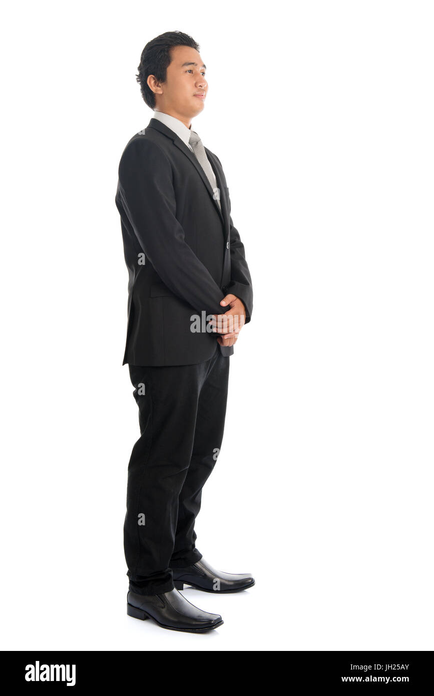 Full body side view of handsome young Southeast Asian businessman ...