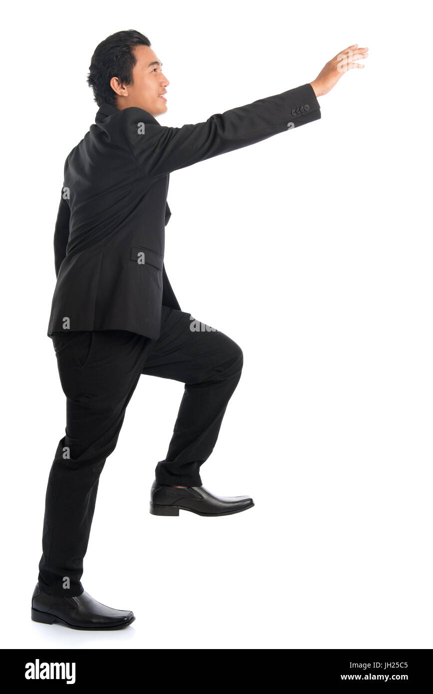 Young man stepping up for success Cut Out Stock Images & Pictures - Alamy