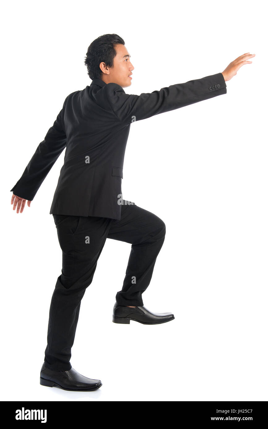 Full body side view of attractive young Southeast Asian businessman ...