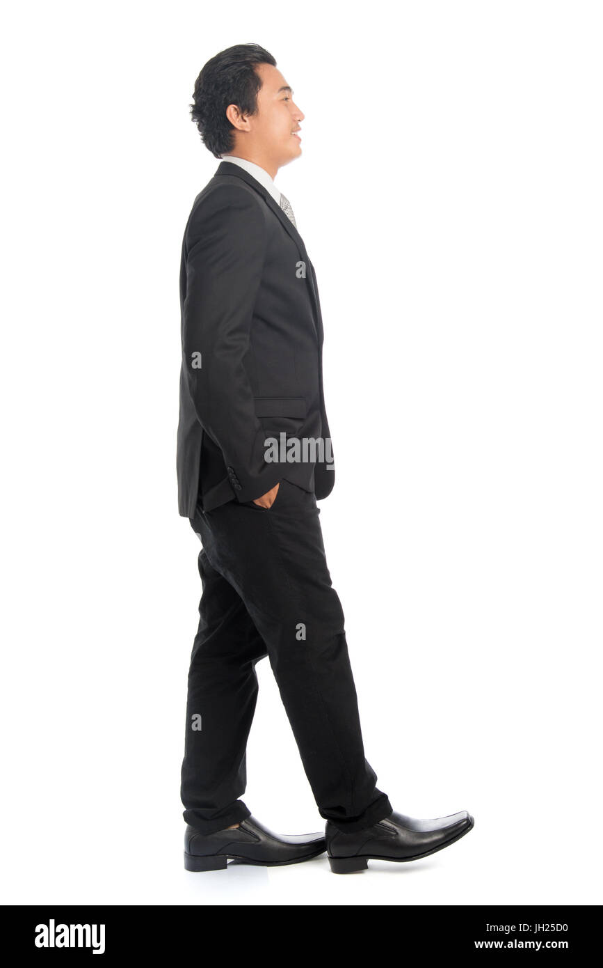Full body side view of attractive young Southeast Asian businessman ...