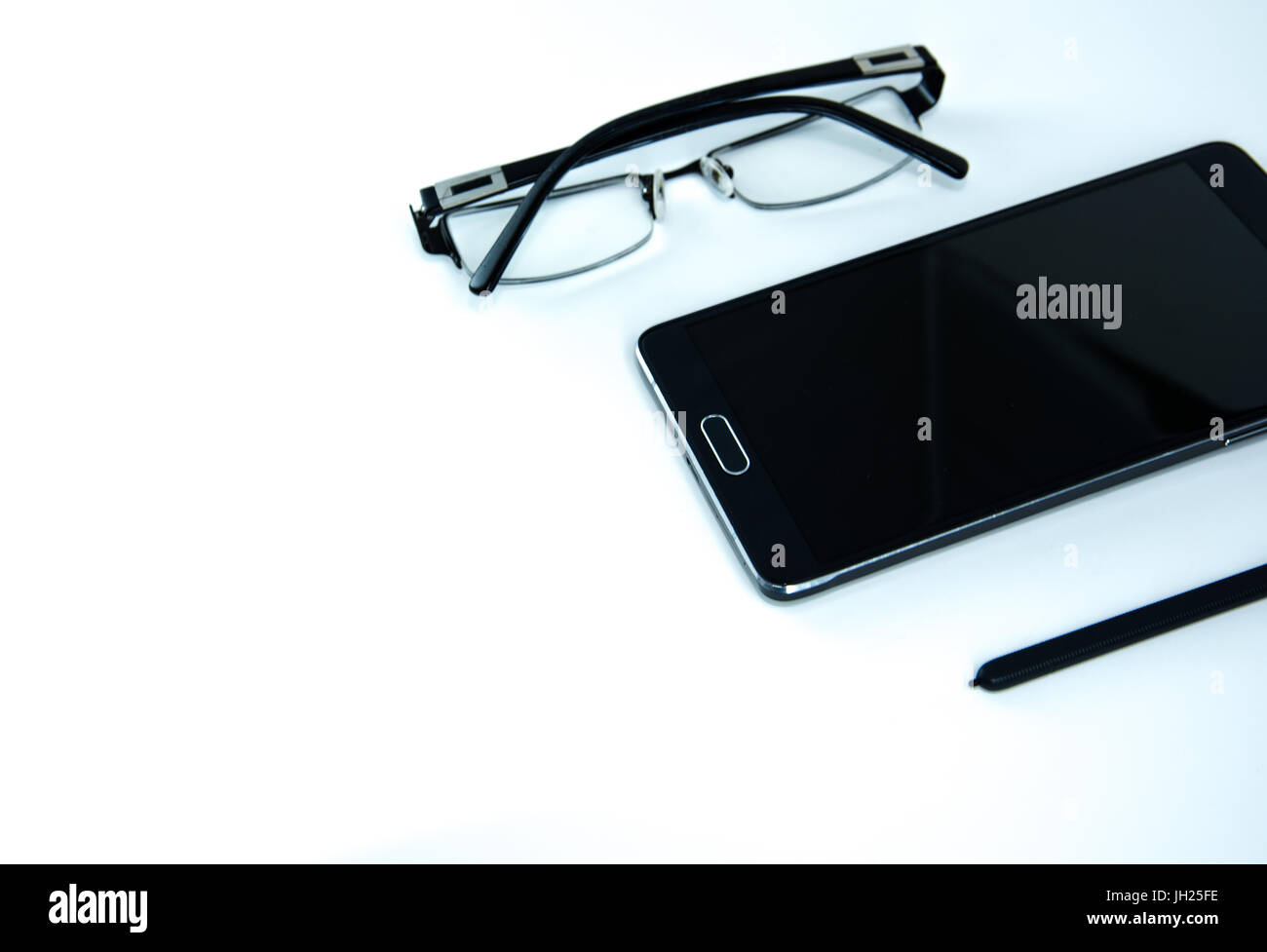 Big black smart phone with smart pen and black eye glasses isolated on ...