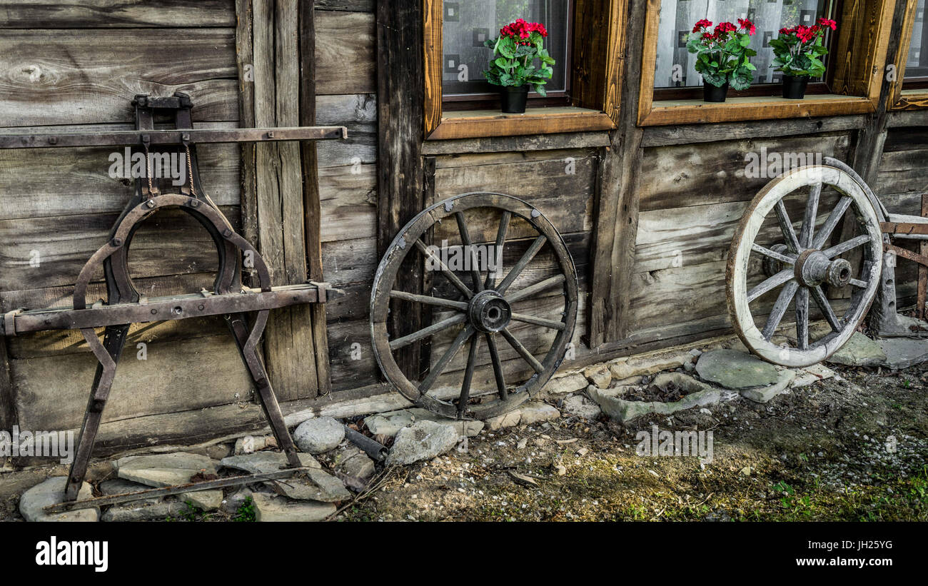 a detail of an old rustic wooden house and wagon wheels Stock Photo - Alamy