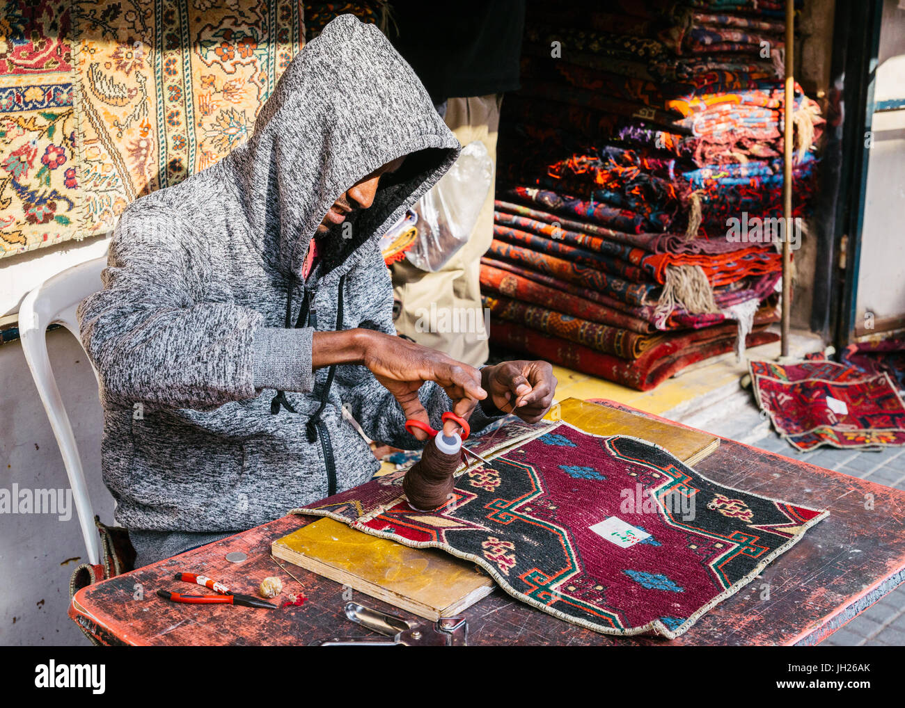 A man hand making a carpet in Tel Aviv, Israel, Middle East Stock Photo ...