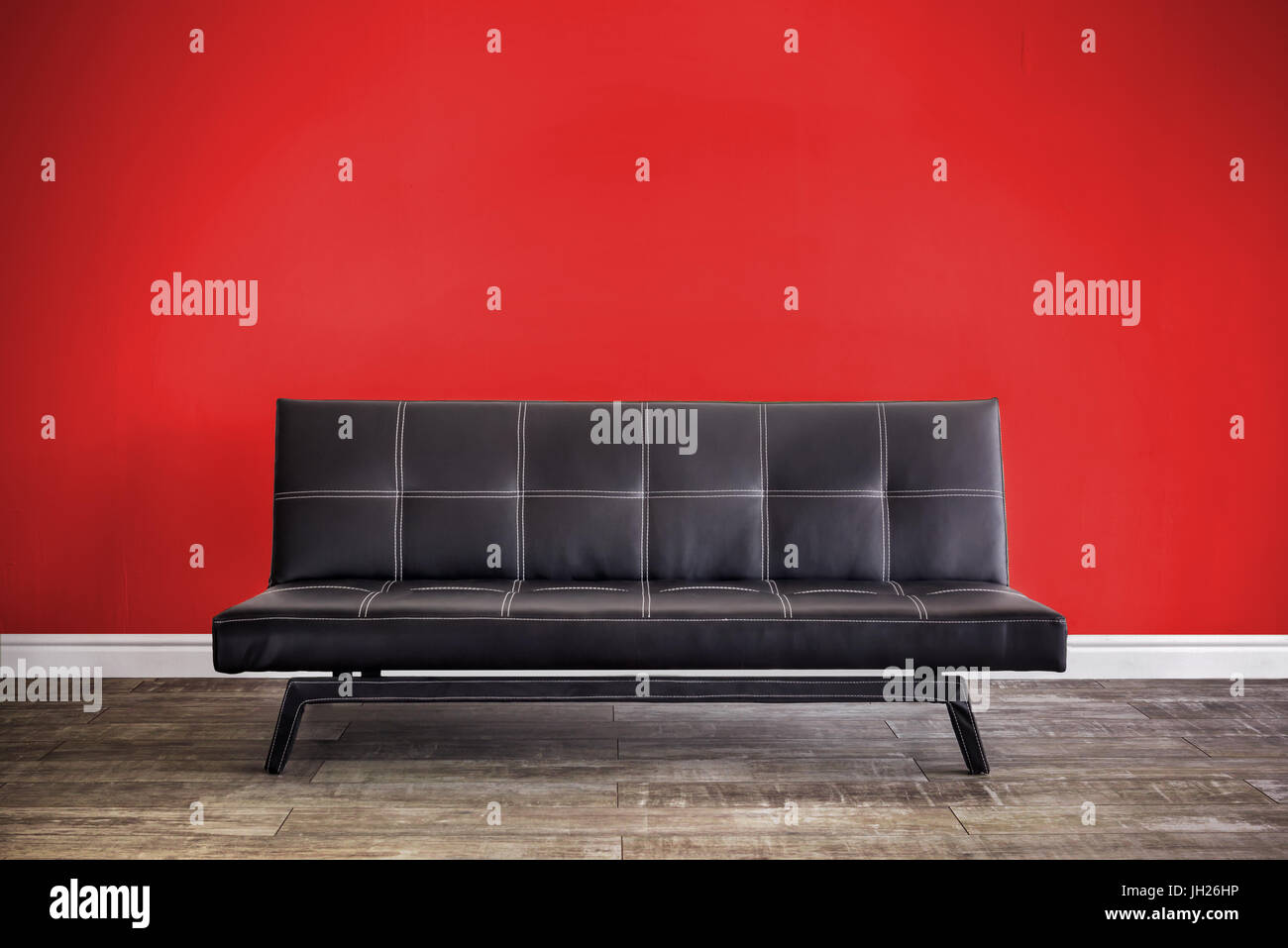 Front view of black leather sofa in interior Stock Photo - Alamy