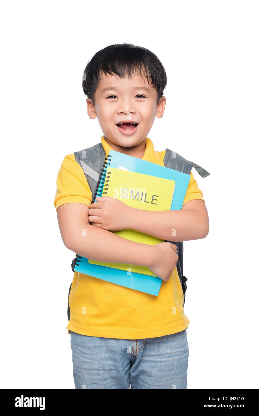 Portrait of cute smiling boy with backpack and colorful books ...