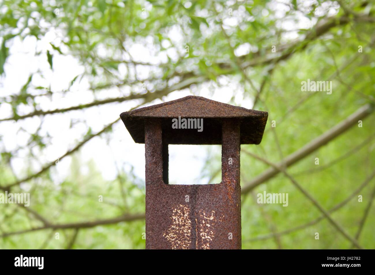 Rusty chimney with green background Stock Photo - Alamy