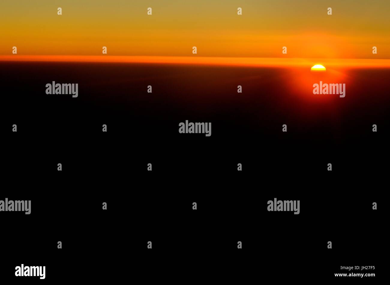 A beautiful aerial view of the rising sun is seen from from a passenger ...