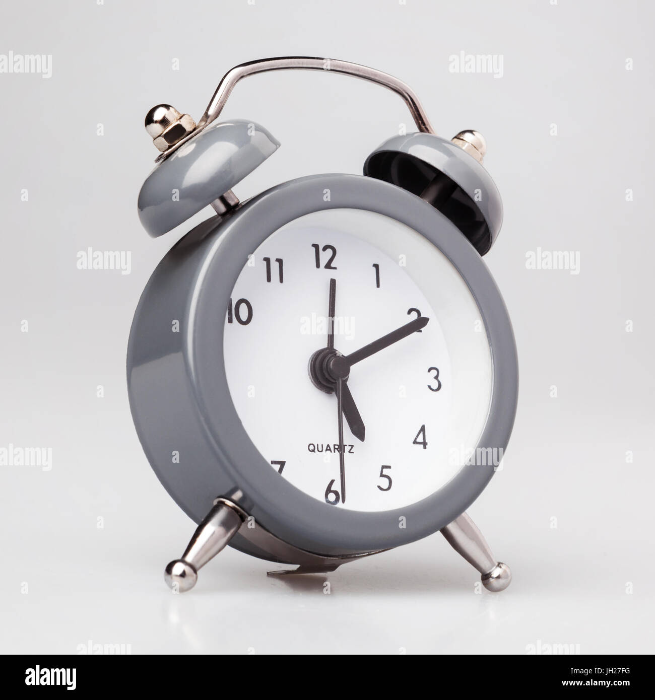Small analog alarm clocks isolated on white background Stock Photo - Alamy