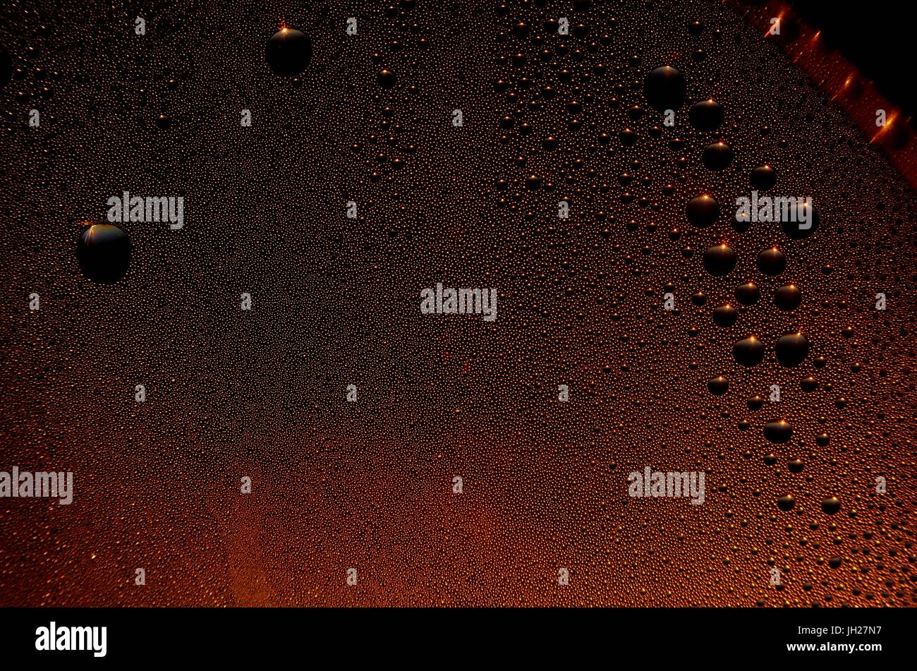 Moisture drops formed on the glass of an aircraft window . The rising ...