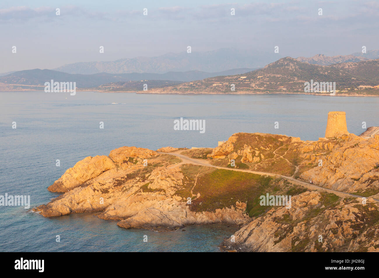 The ancient Genoese tower overlooking the blue sea surrounding the ...