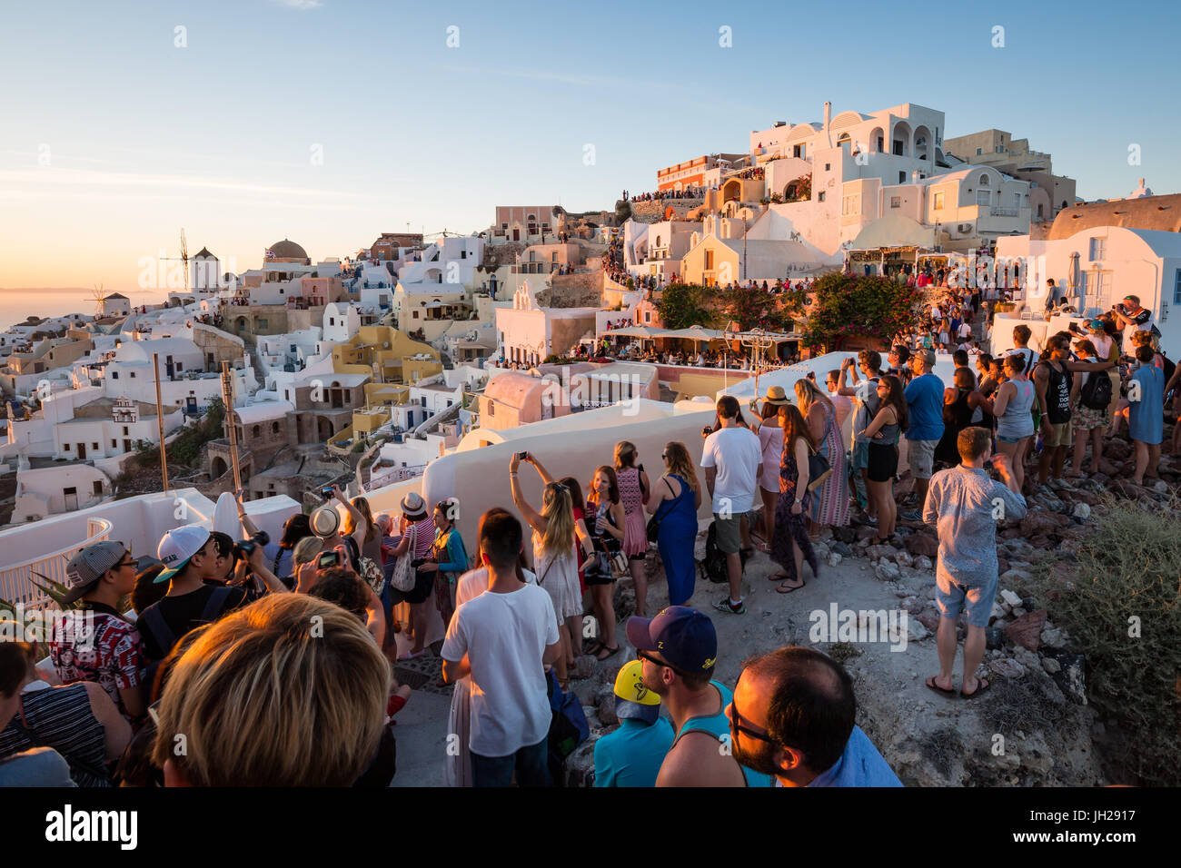 People line the town's walls, for the famous Oia sunset on the Greek ...