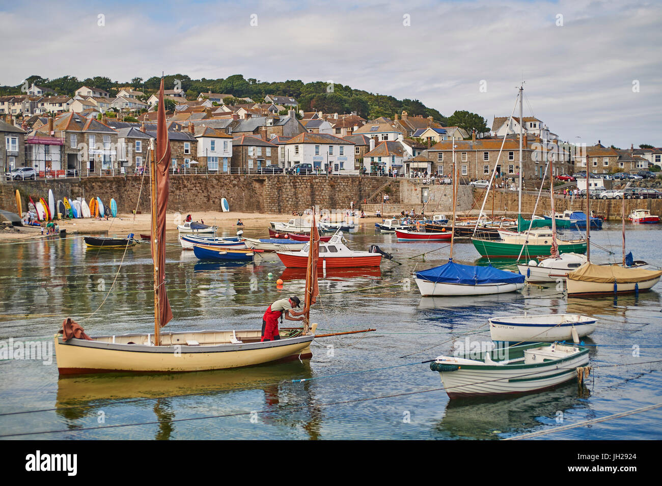 Fisherman makes ready his oyster dredger setting out mousehole harbour ...