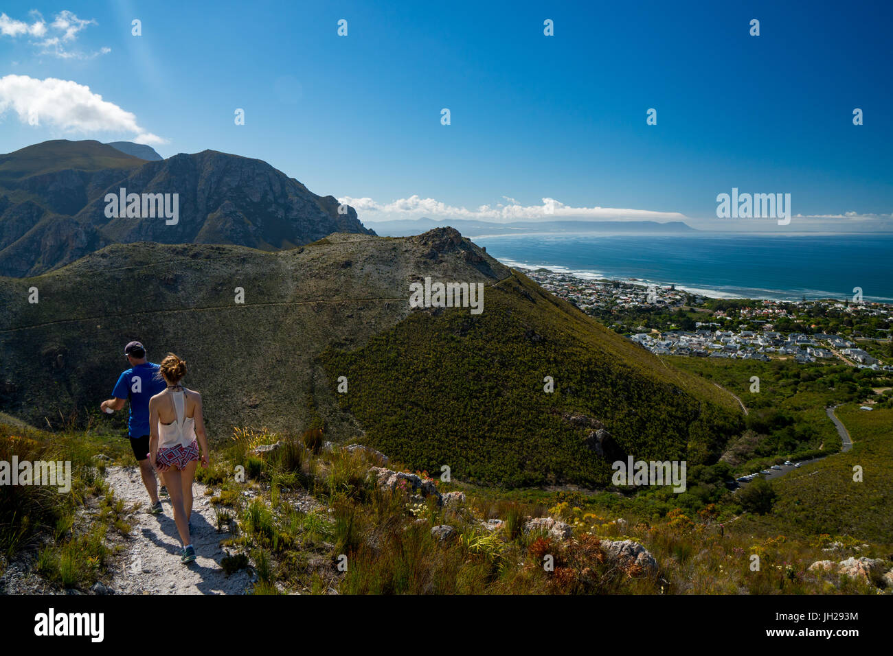Man and woman hikers walking down into Hermanus from the mountain ...