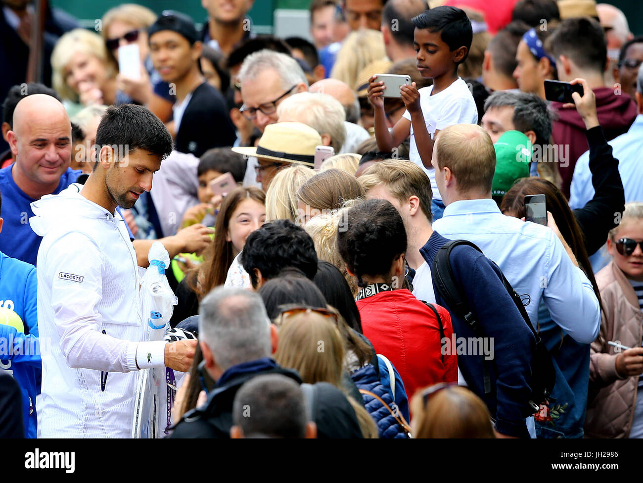 Novak Djokovic signs autographs for fans on day Nine of the Wimbledon ...