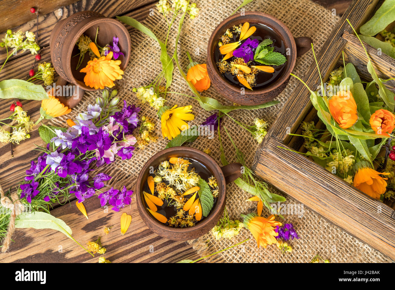 Two ceramic cups of healthy herbal tea with decoction of dry and fresh ...