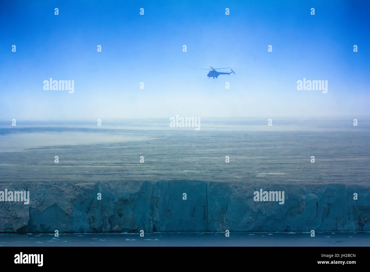 Helicopter with glaciologists and tourists-extreme over clouded Arctic ...