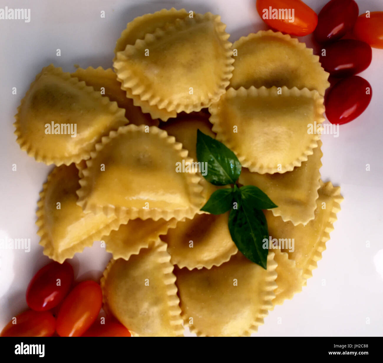 Italian pasta, ravioli, with basil and tomatoes Stock Photo - Alamy
