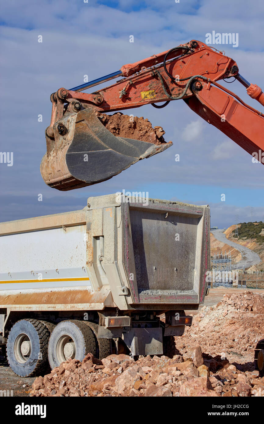 Bulldozer loading sand into the truck Stock Photo - Alamy
