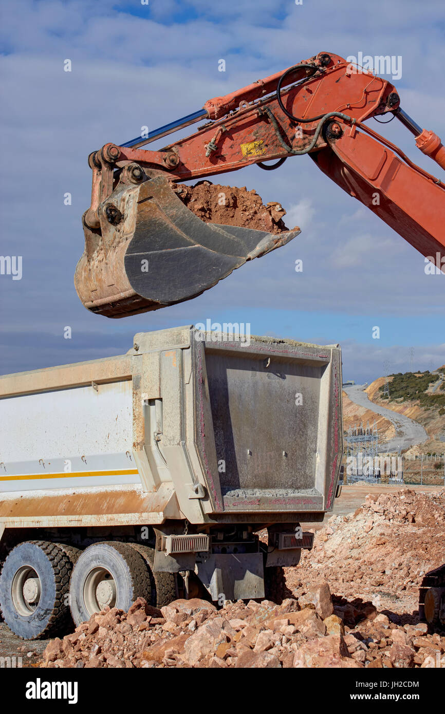 Bulldozer loading sand into the truck Stock Photo - Alamy