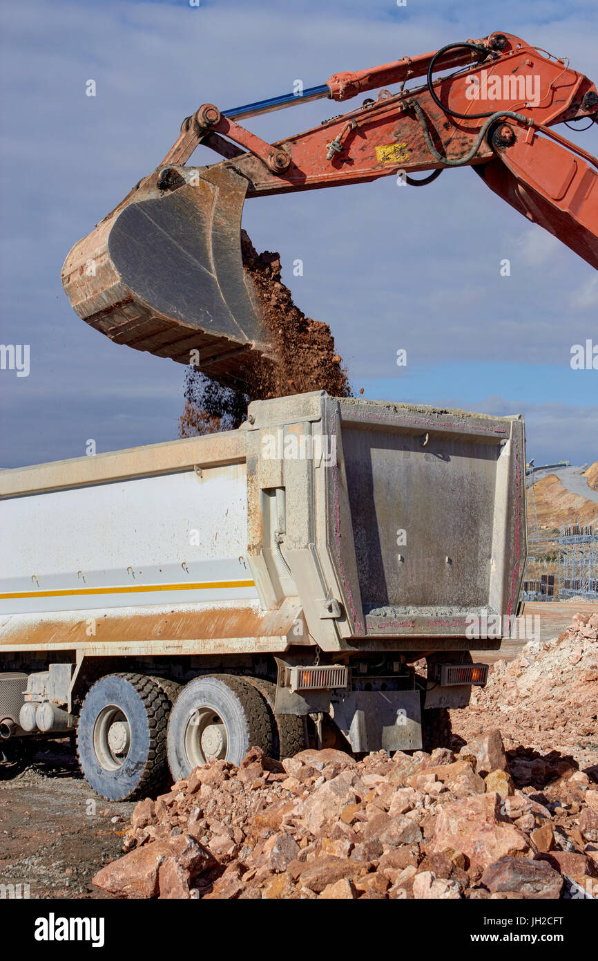 Bulldozer loading sand into the truck Stock Photo - Alamy