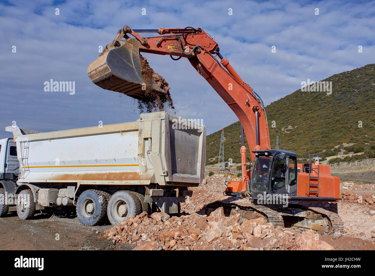 Bulldozer loading sand into the truck Stock Photo - Alamy