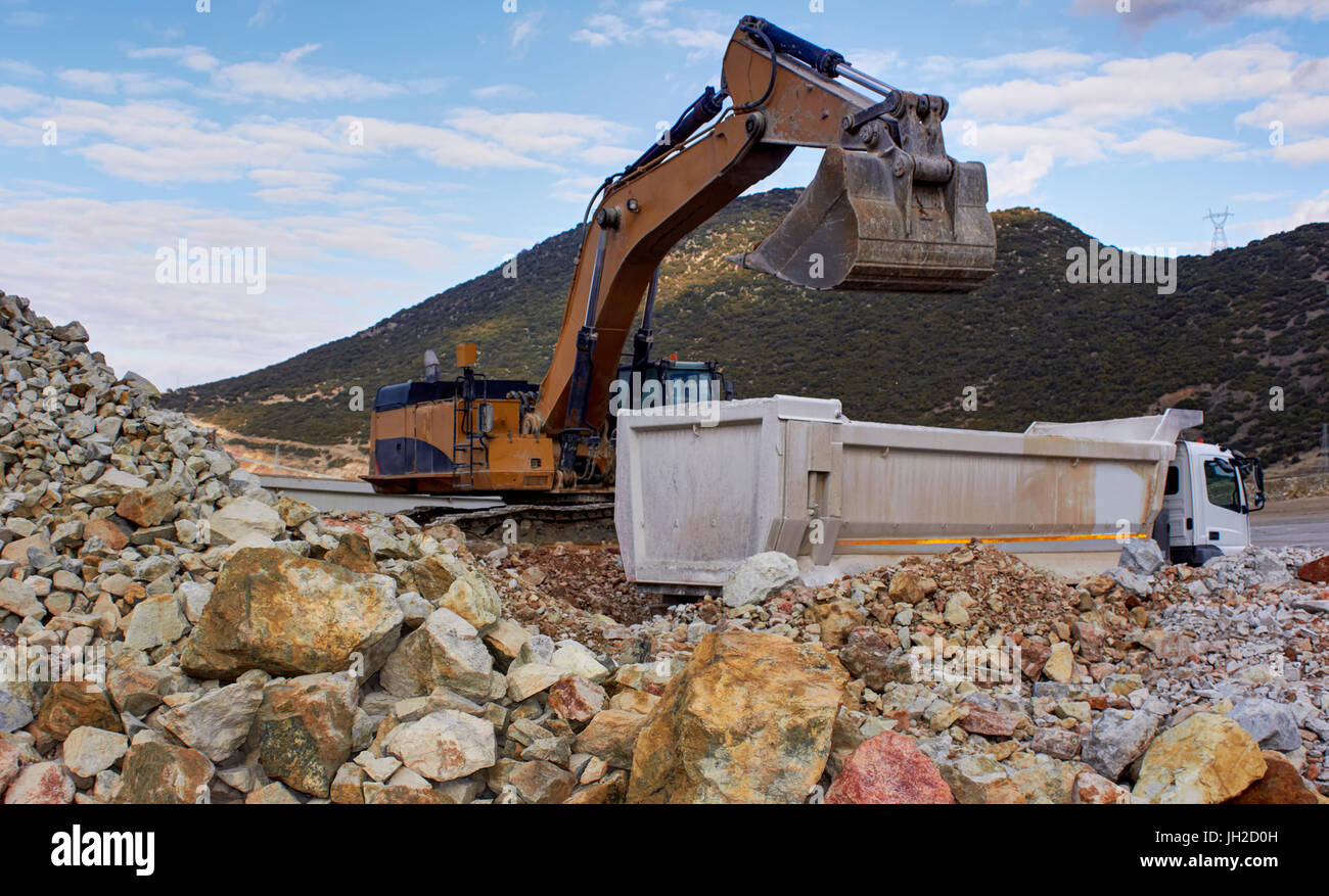 Bulldozer loading sand into the truck Stock Photo - Alamy