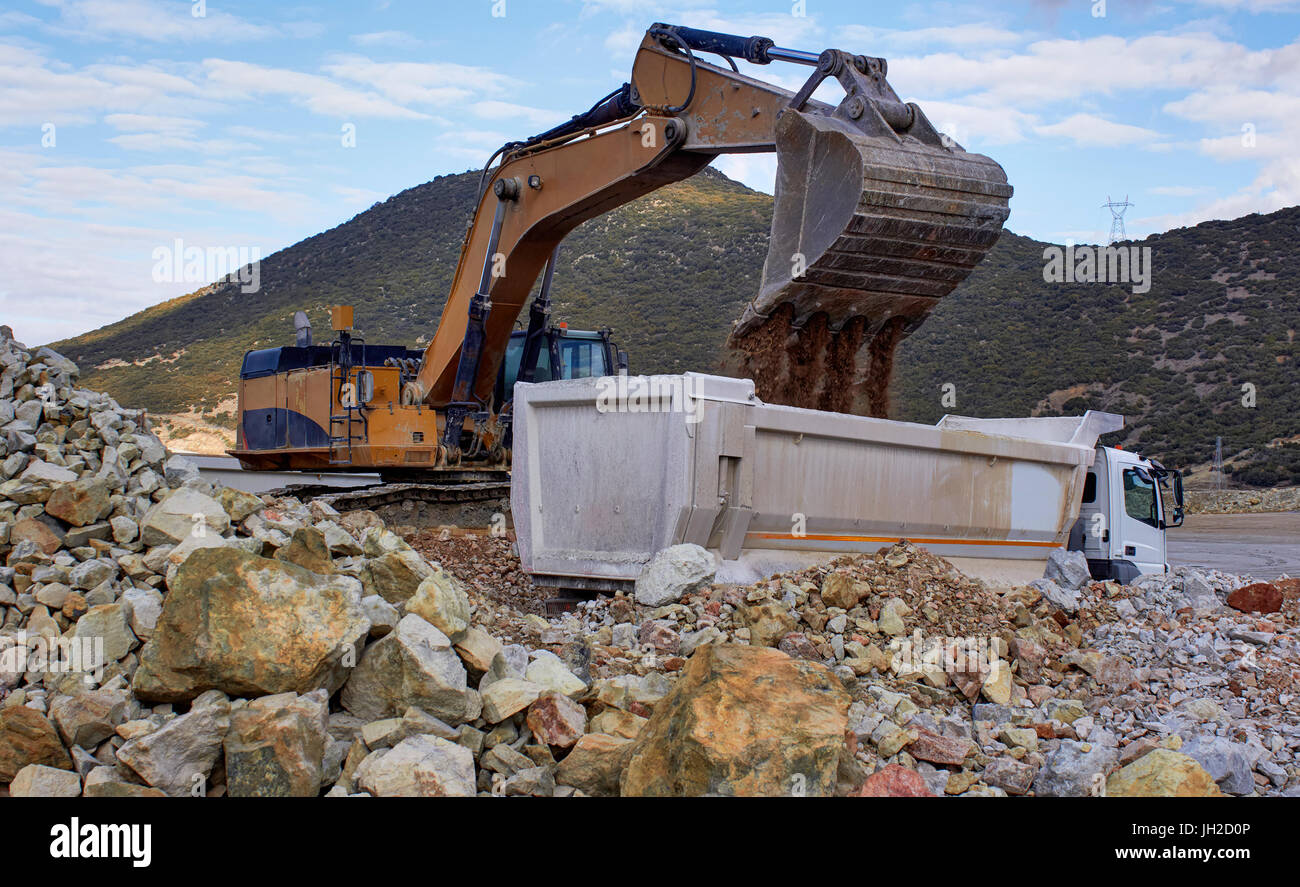 Bulldozer loading sand into the truck Stock Photo - Alamy