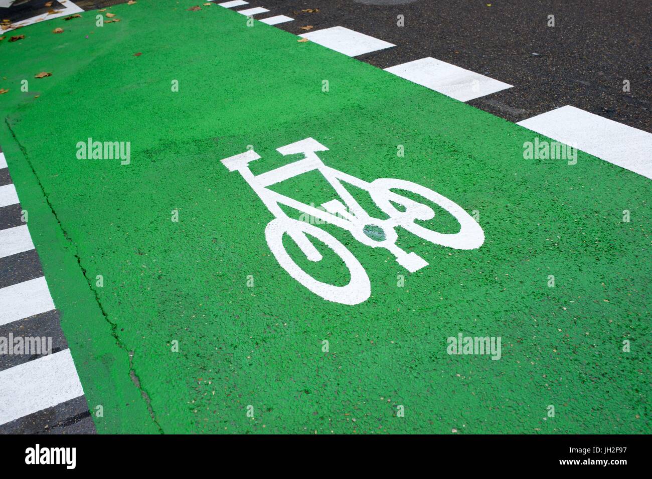 Bike lane sign painted on a street Stock Photo - Alamy
