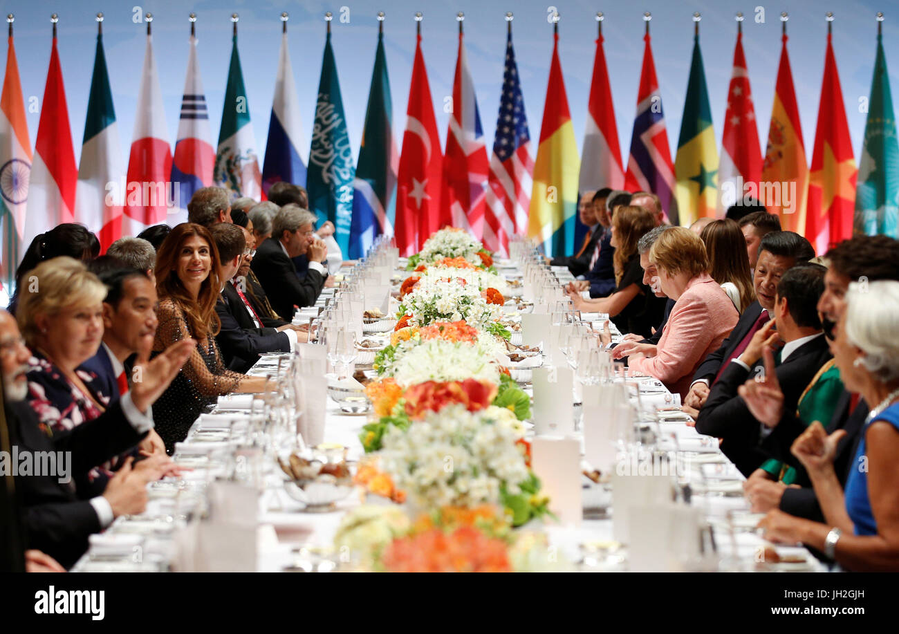 Guests of the G20 Summit sit together during a meal in Hamburg, 07 July ...