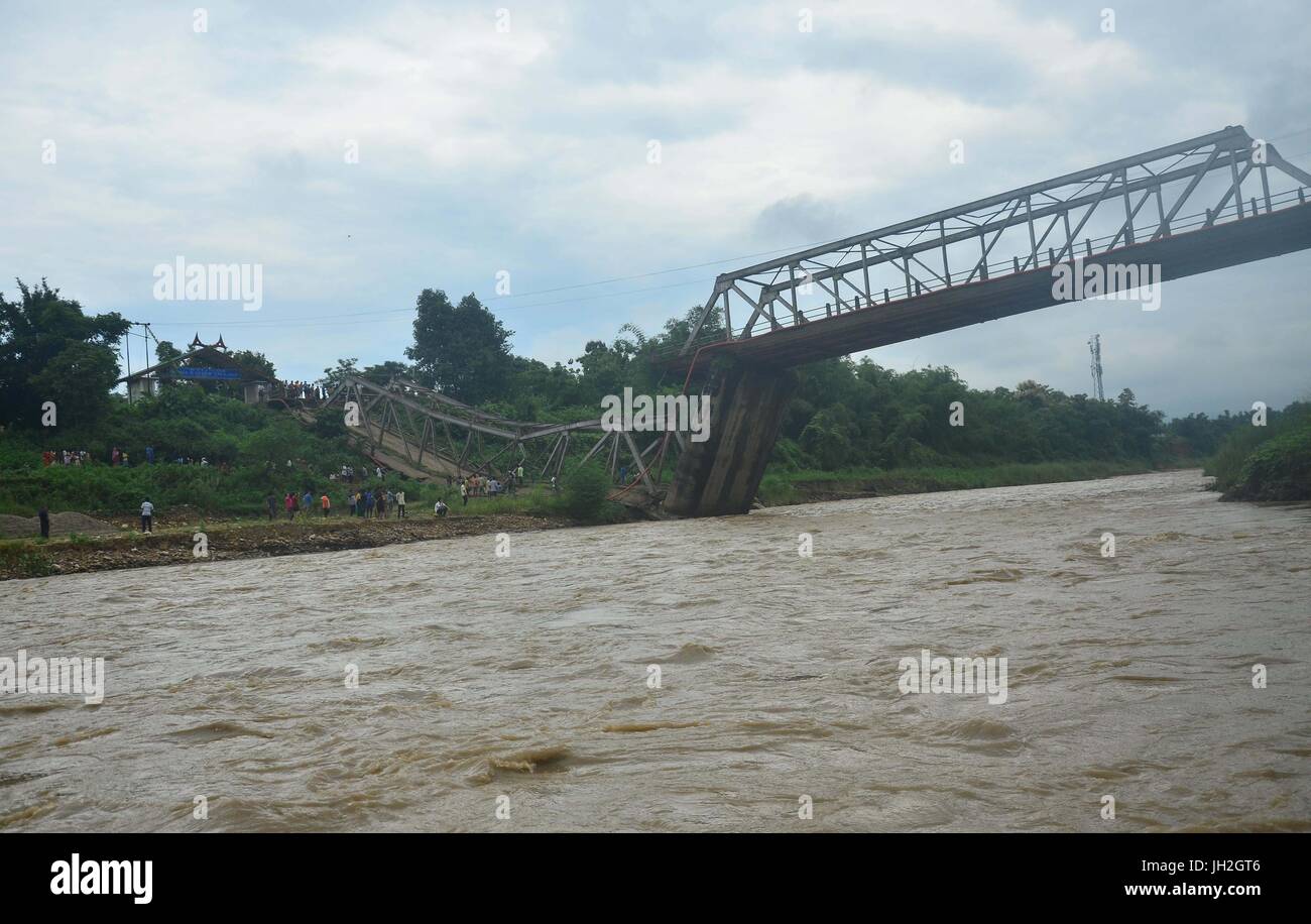 Dimapur, India. 12th July, 2017. Onlookers look on at the collapse ...