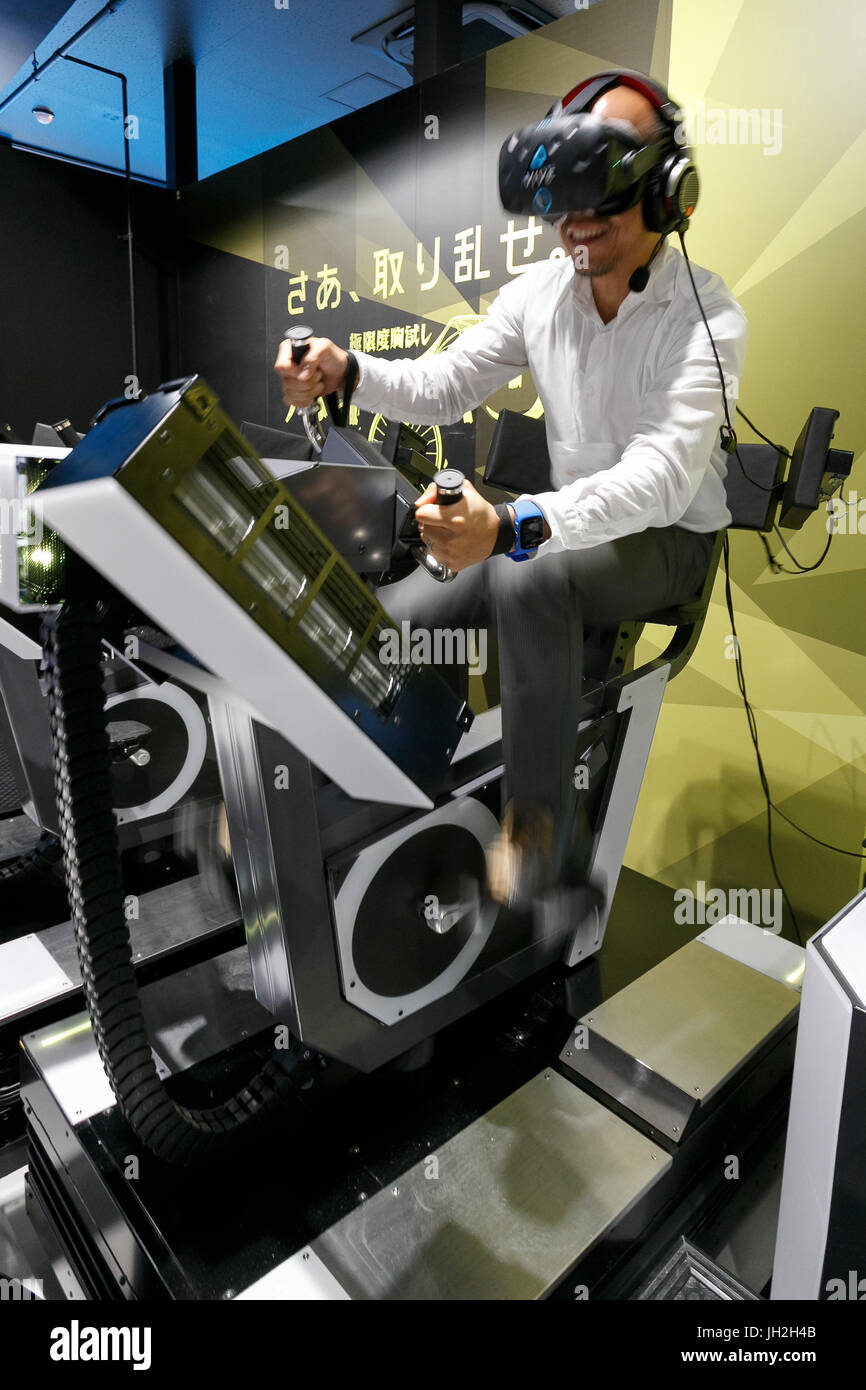 Tokyo, Japan. 12th Jul, 2017. A guest tests a VR simulator during a ...