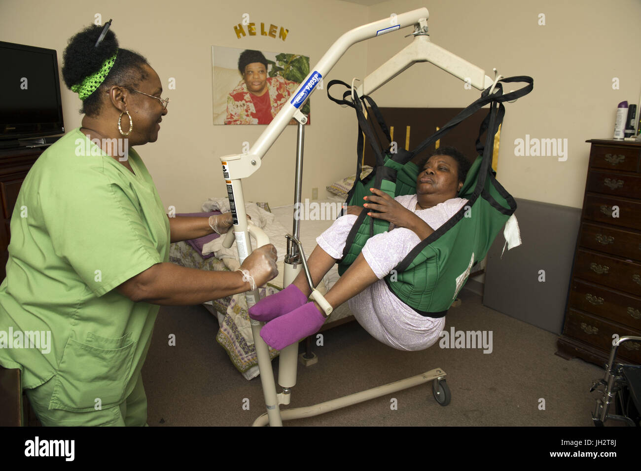 Waycross, Georgia, USA. 3rd Aug, 2014. A caregiver lifts HELEN LOTSON ...