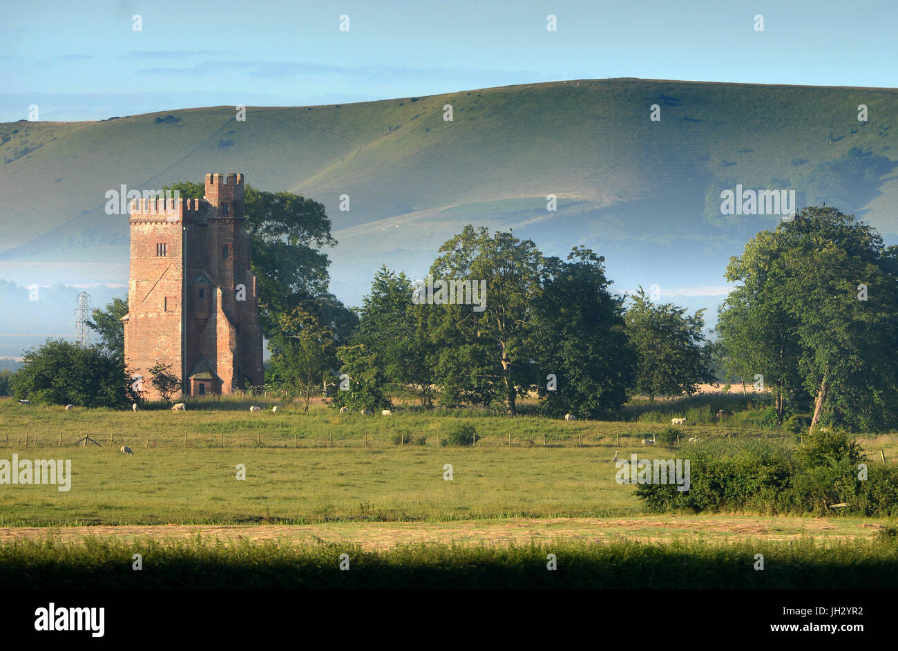 Laughton, East Sussex. The rising sun lights up the South Downs and ...