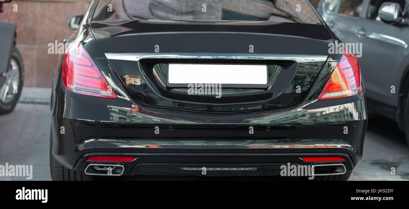 Back view of big luxury expensive sedan car trunk. Black colored. LED ...