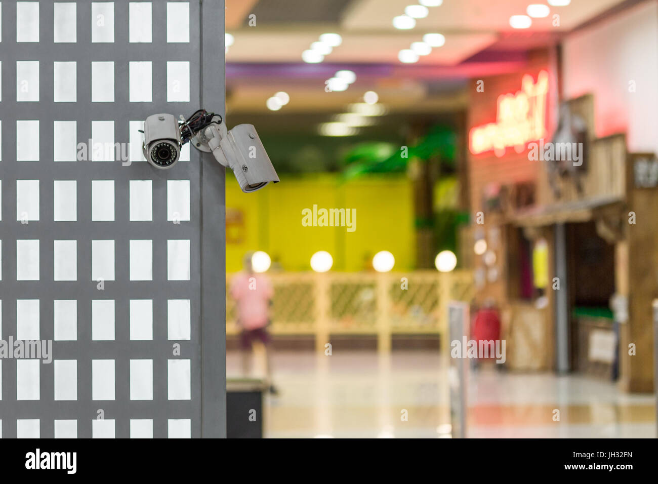 CCTV security cameras on a wall corner in shopping and entertainment ...