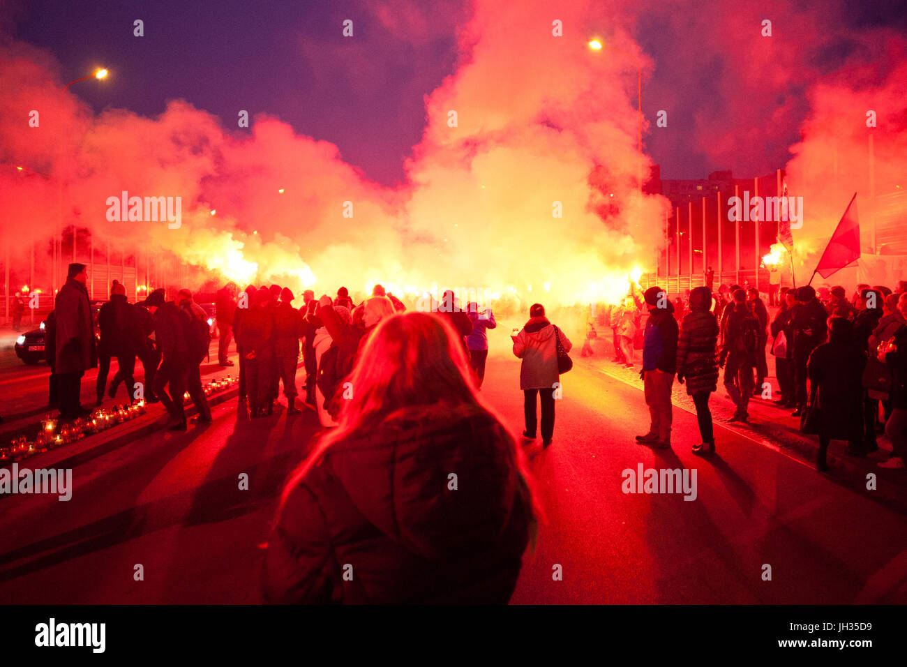 Crowd people on the road with flares, smoke, fog, night Stock Photo - Alamy
