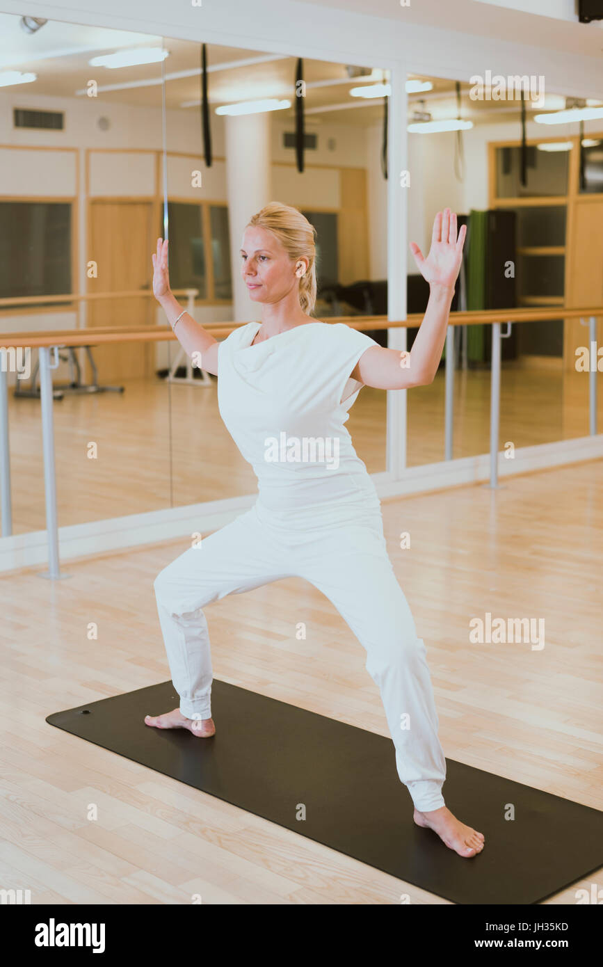 Woman practicing yoga in the goddess pose Stock Photo - Alamy