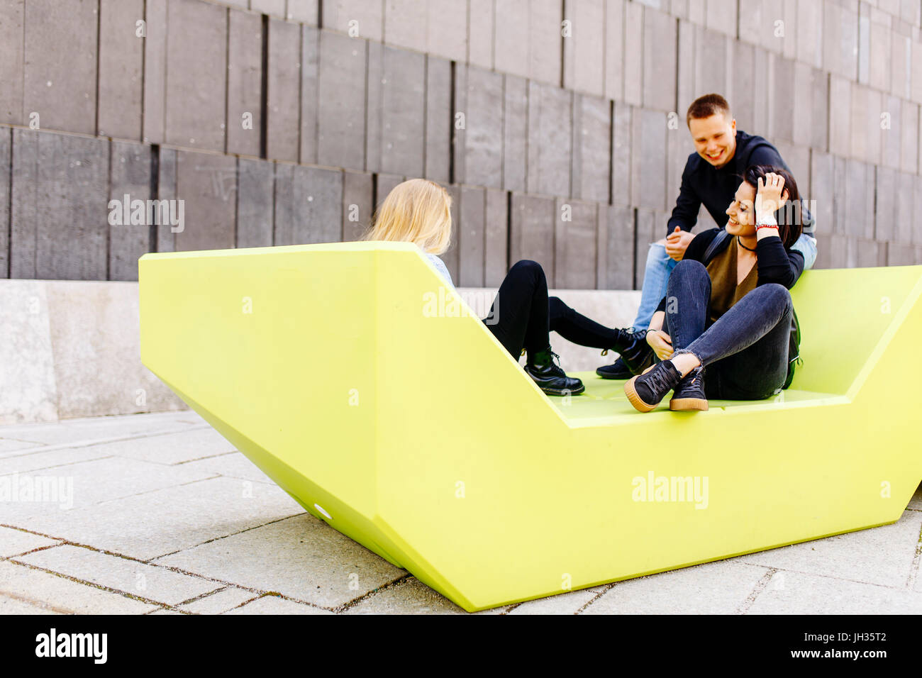Young people sitting on the modern bench on street in Vienna, Austria ...